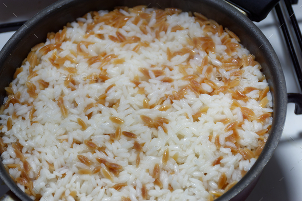 Rice cooked with roasted pasta in the pan Stock Photo by xewex | PhotoDune