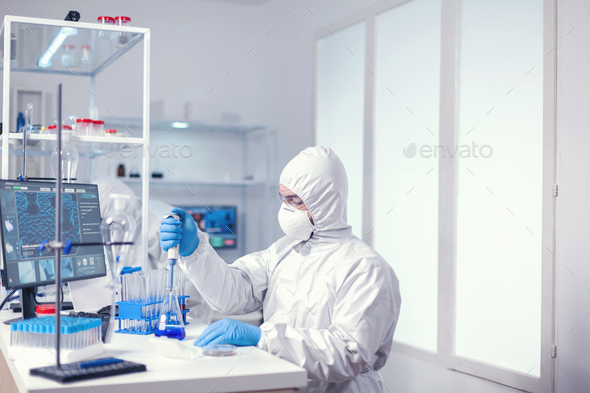 Chemist in modern laboratory doing research using dispenser Stock Photo ...