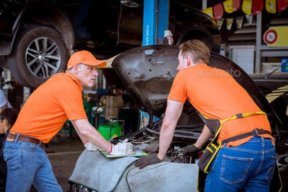 Car mechanic open car hood repairs and check problem system on hand to ...