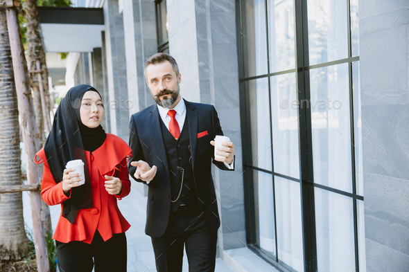 Hispanic Businessman with Asian Arab Muslim business women talking ...