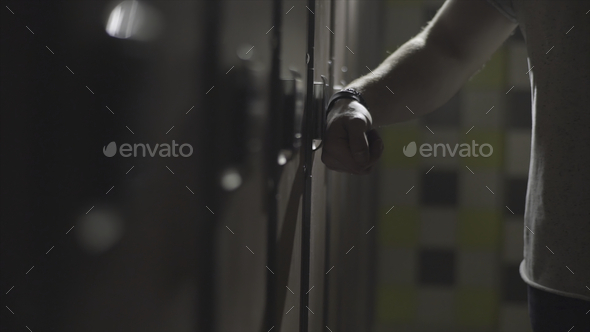 Man's hand opening locker with electric key on his wrist at gym in the ...