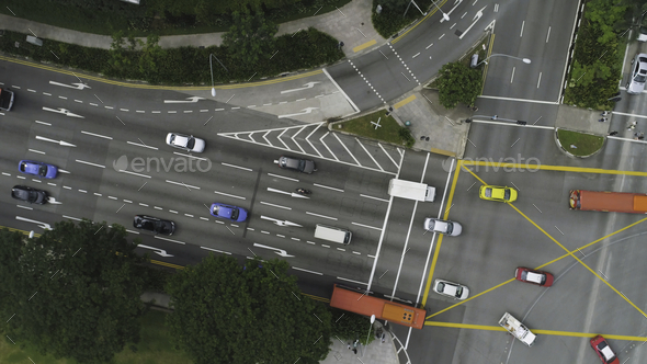 Top view of a city intersection with a bus, cars and people crossing ...