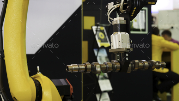 Industrial robotic machine putting down a metal detail, industrial ...