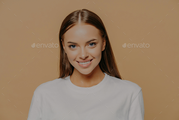 beautiful woman with long dark straight hair smiles gently wears casual ...