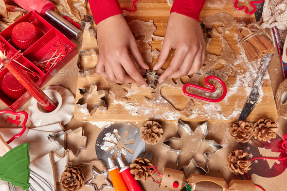 Faceless woman cuts stars from gingerbread dough prepares Christmas ...