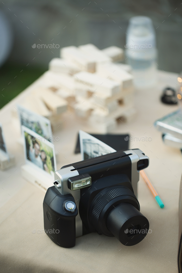 Camera with photos of guests in the design of the wedding photo zone ...
