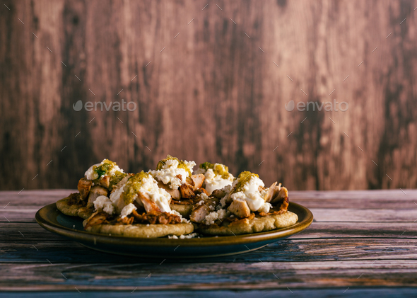 Sopitos, typical mexican dish on wooden table. Sopes, Mexican snack ...