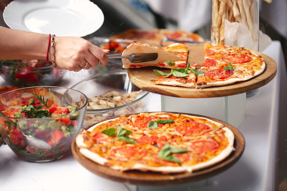 Self-service at the buffet. A variety of pizza and salads. Stock Photo ...