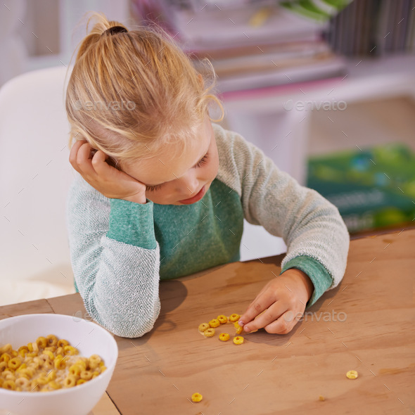 I dont like this cereal. Shot of a little girl looking sad while eating ...