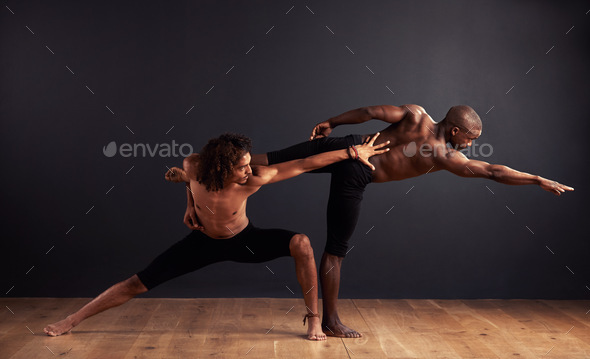 Two male contemporary dancers performing a dramatic pose in front of a ...