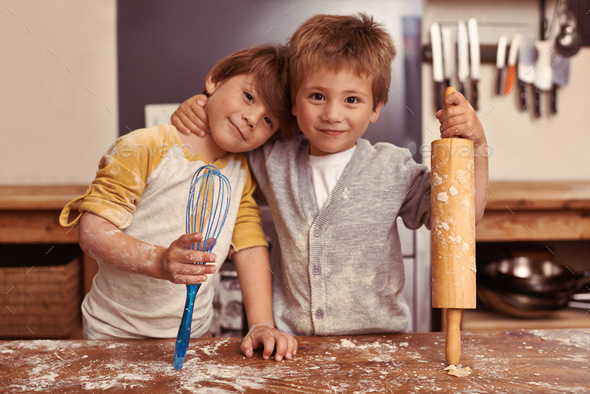 We bake as a team. Cropped shot of two young brothers baking in the ...