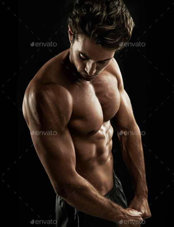 Ripped. Muscular young man showing off his defined body. Stock Photo by ...
