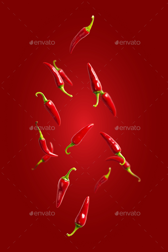 Fresh red chilli peppers floating in the air. food levitation. Falling ...