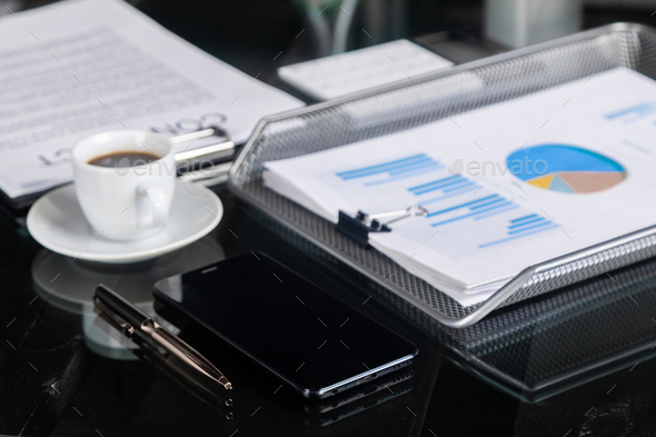 Signing a contract for a Cup of coffee close-up Stock Photo by traimakivan