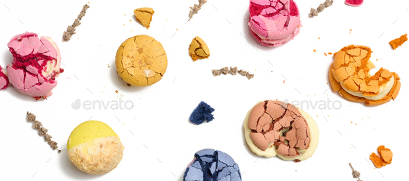 Broken round macarons with crumbs on a white background, delicious ...