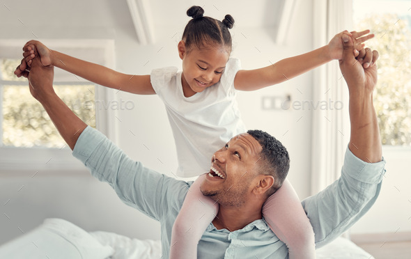 Dad piggy back girl in family home having fun, quality time and relax ...