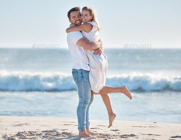 Hug, happy and couple at the beach for love, peace and relax on a ...