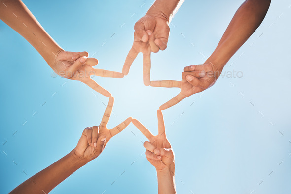Hands, star and teamwork with friends in a huddle on a clear blue sky ...