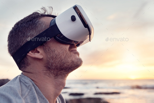 VR, beach and metaverse with a man outdoor in a nature using a wireless ...