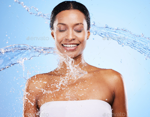 Woman, water splash and shower with body cleaning and smile with ...