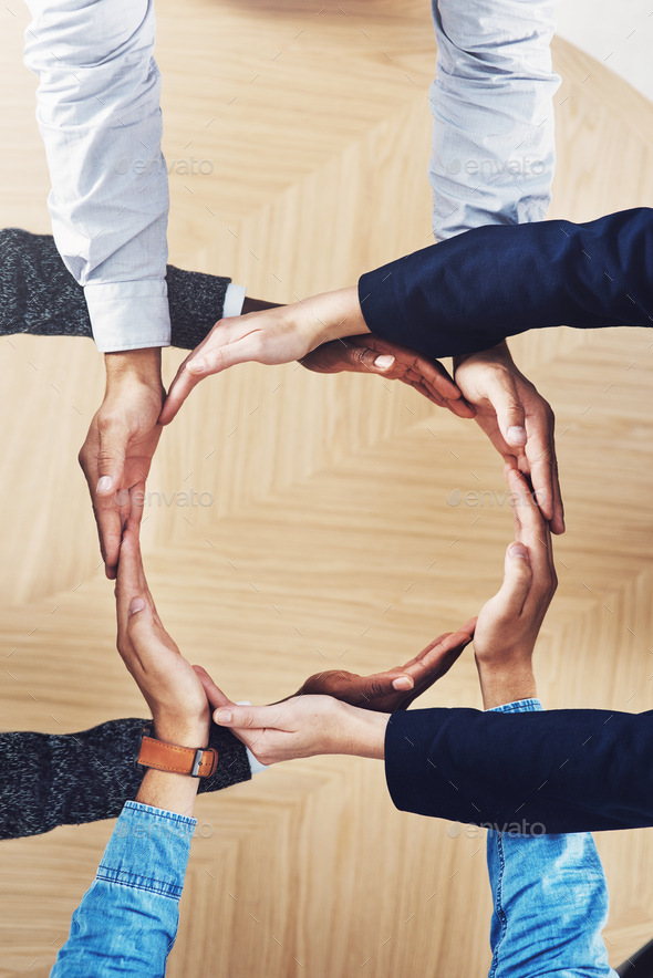 High angle shot of a group of unidentifiable businesspeople forming a ...