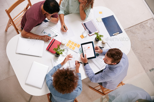 High angle shot of a group of businesspeople working together around a ...