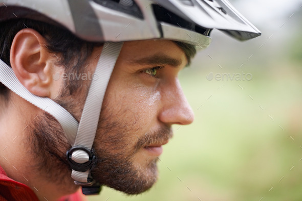 Eye on the prize. Closeup profile of a cyclist wearing a helmet. Stock ...