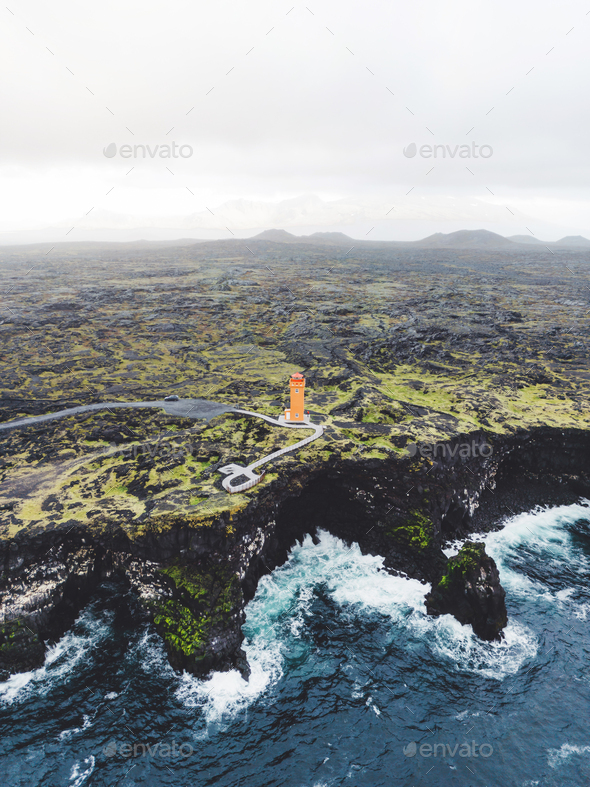 Vertical photo of Svortuloft Lighthouse on the volcanic coast of ...