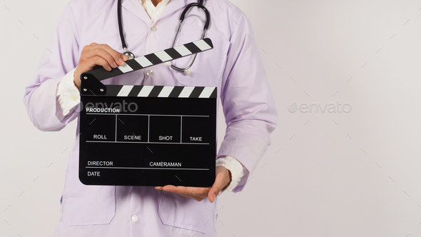 Doctor's holding Black Clapper board in hand on white background ...