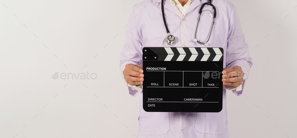 Doctor's holding Black Clapper board in hand on white background ...