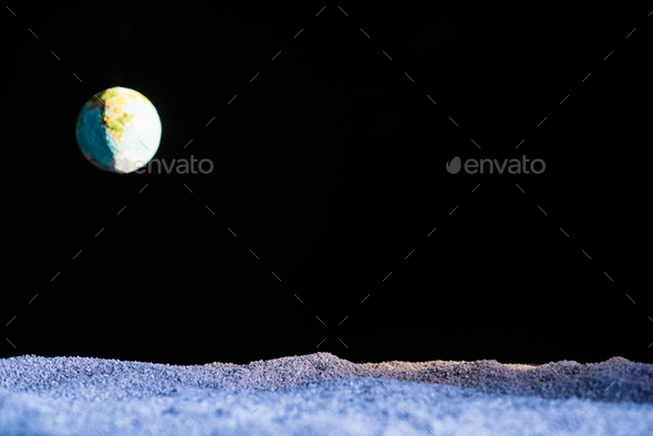 sandy ground with blurred planet Earth in space isolated on black Stock ...