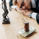 selective focus of tired judge in glasses sleeping on table near gavel ...
