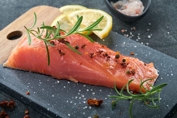 Salmon fish piece. Fresh raw salmon fish piece on marble board stand ...