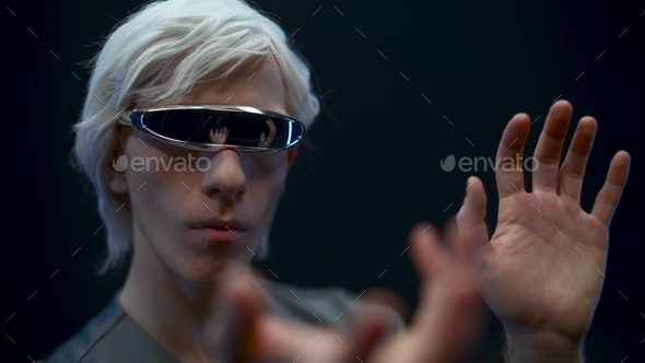 Smart man touching invisible interface in VR glasses closeup. Augmented ...
