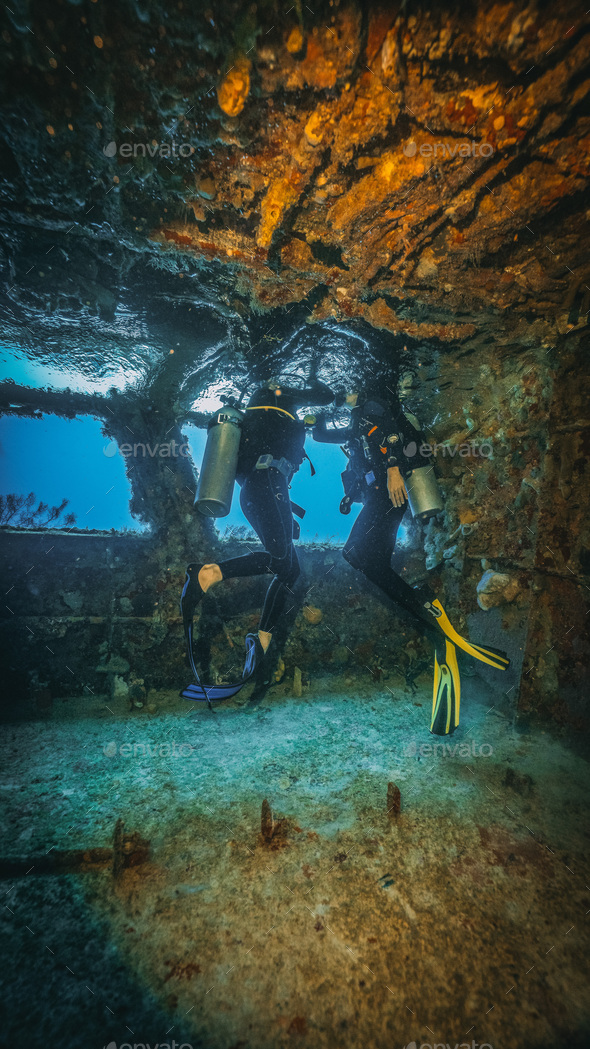 two scuba diver checking a small dome of air into a shipwreck Stock ...
