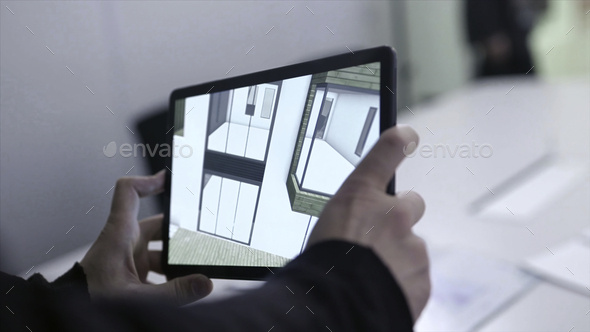 Virtual drawing of house on tablet. Stock. Businessman holding tablet ...