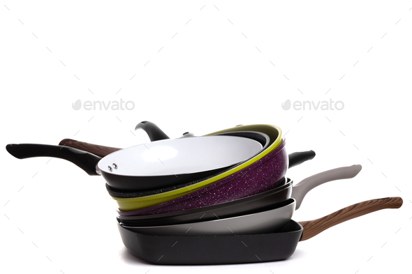 stack of new stylish modern non-stick frying pans on white background ...