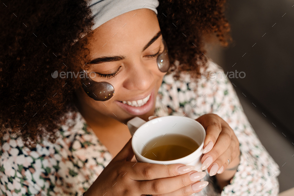 Portrait of young beautiful smiling african woman drinking tea Stock ...