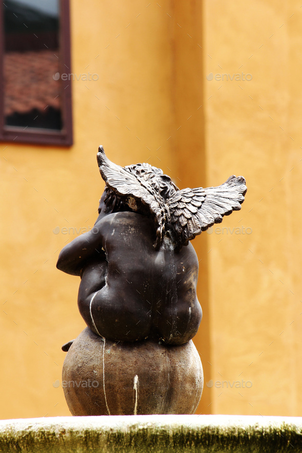 Cupid sitting on stone. Stock Photo by puripatt | PhotoDune