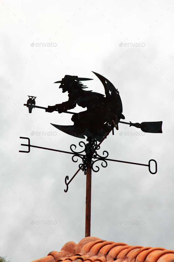 Witch riding a broom on the roof. Stock Photo by puripatt | PhotoDune