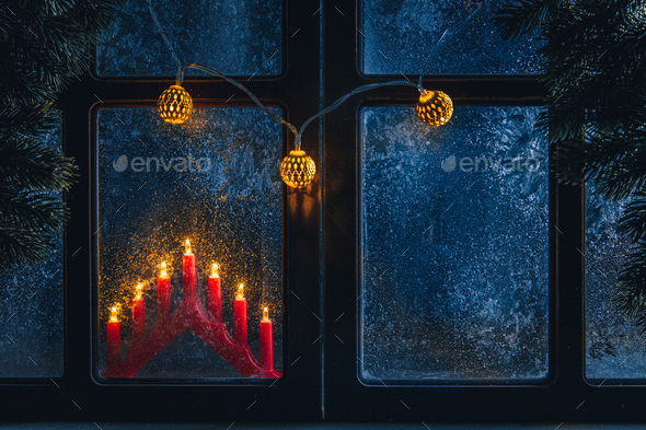 Christmas, winter composition. Christmas Candles behind a frozen window ...