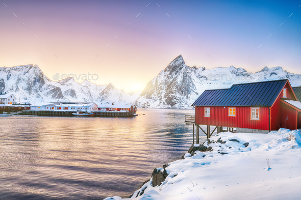 Traditional Norwegian red wooden houses (rorbuer) on the shore of ...