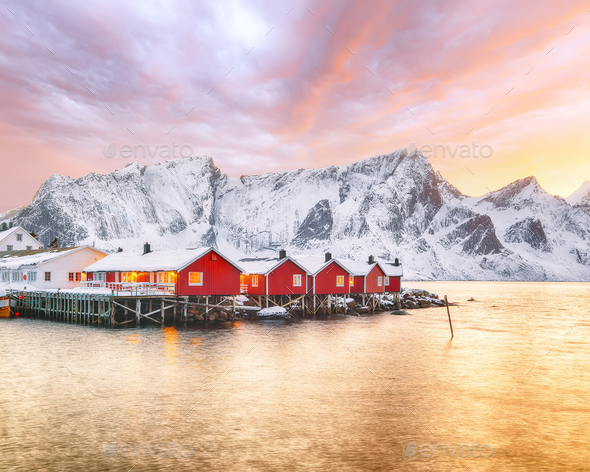 Traditional Norwegian red wooden houses (rorbuer) on the shore of ...