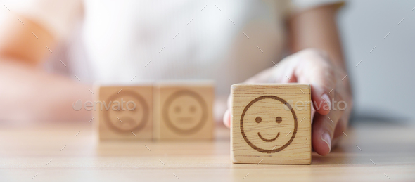 Hand choosing smile face from Emotion block Stock Photo by JoPanwatD