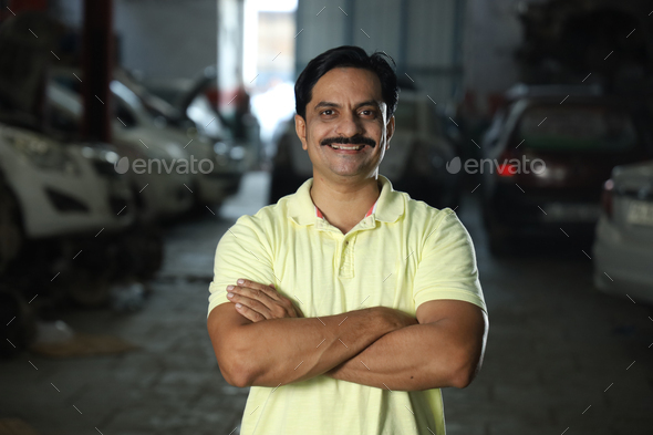 Shallow focus photo of a happy Indian client in a motor shop Stock ...