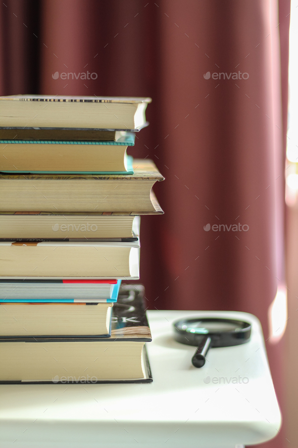 What to read in quarantine. A stack of books on a nightstand by the ...