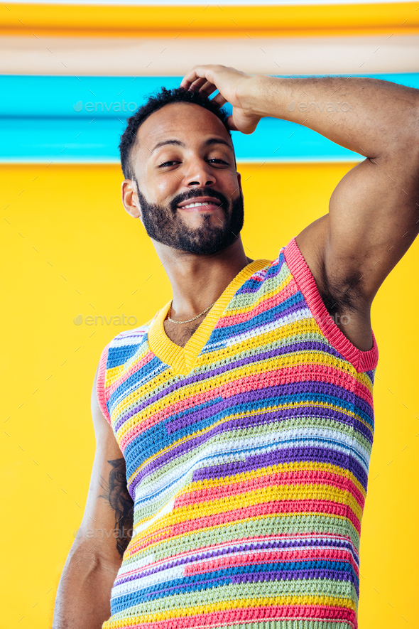 Man posing on colored backgrounds in studio wearing trendy clothes ...