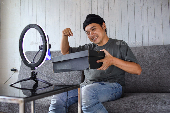 Male influencer or youtuber reviewing product online Stock Photo by ...