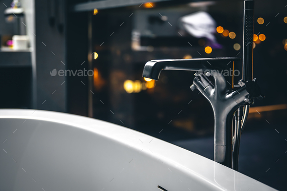 Steel faucet in the interior of a modern bathroom with a window. Stock ...