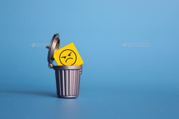 Wooden cube with angry face icon inside dustbin, trash can. Stock Photo ...